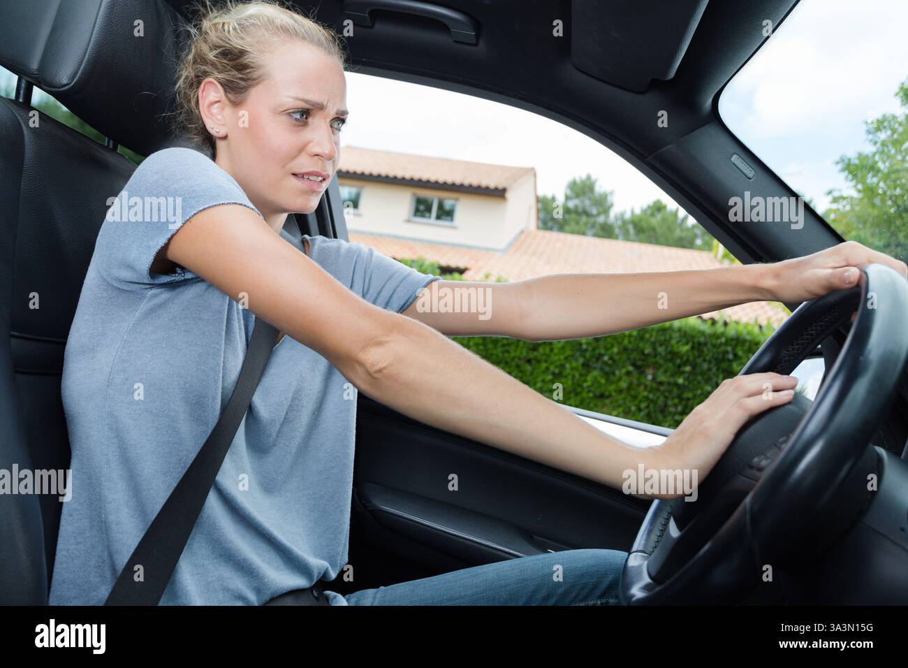 closeup photo of annoyed woman driving car and honking Stock Photo - Alamy