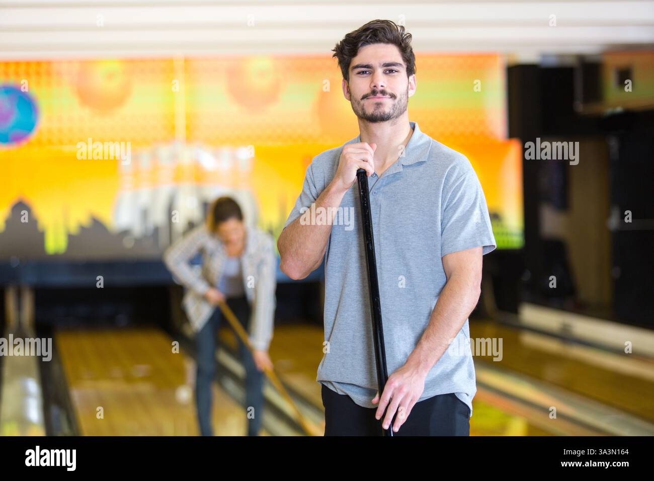 man cleaning bowling alley Stock Photo - Alamy