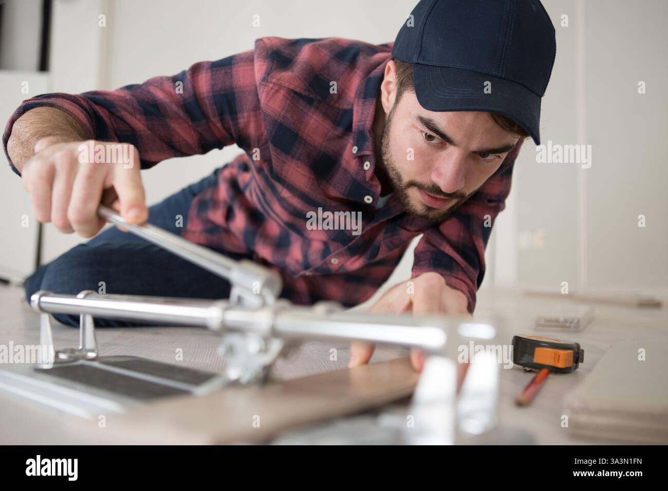 workman cutting ceramic tiles Stock Photo - Alamy