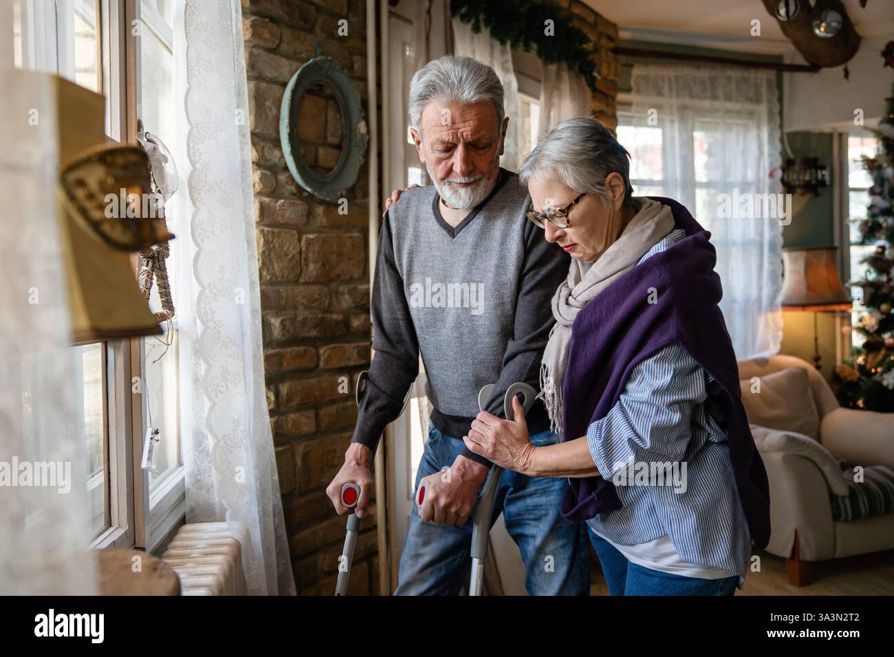 Upset elder wife comforting senior husband, talking to anxious man ...
