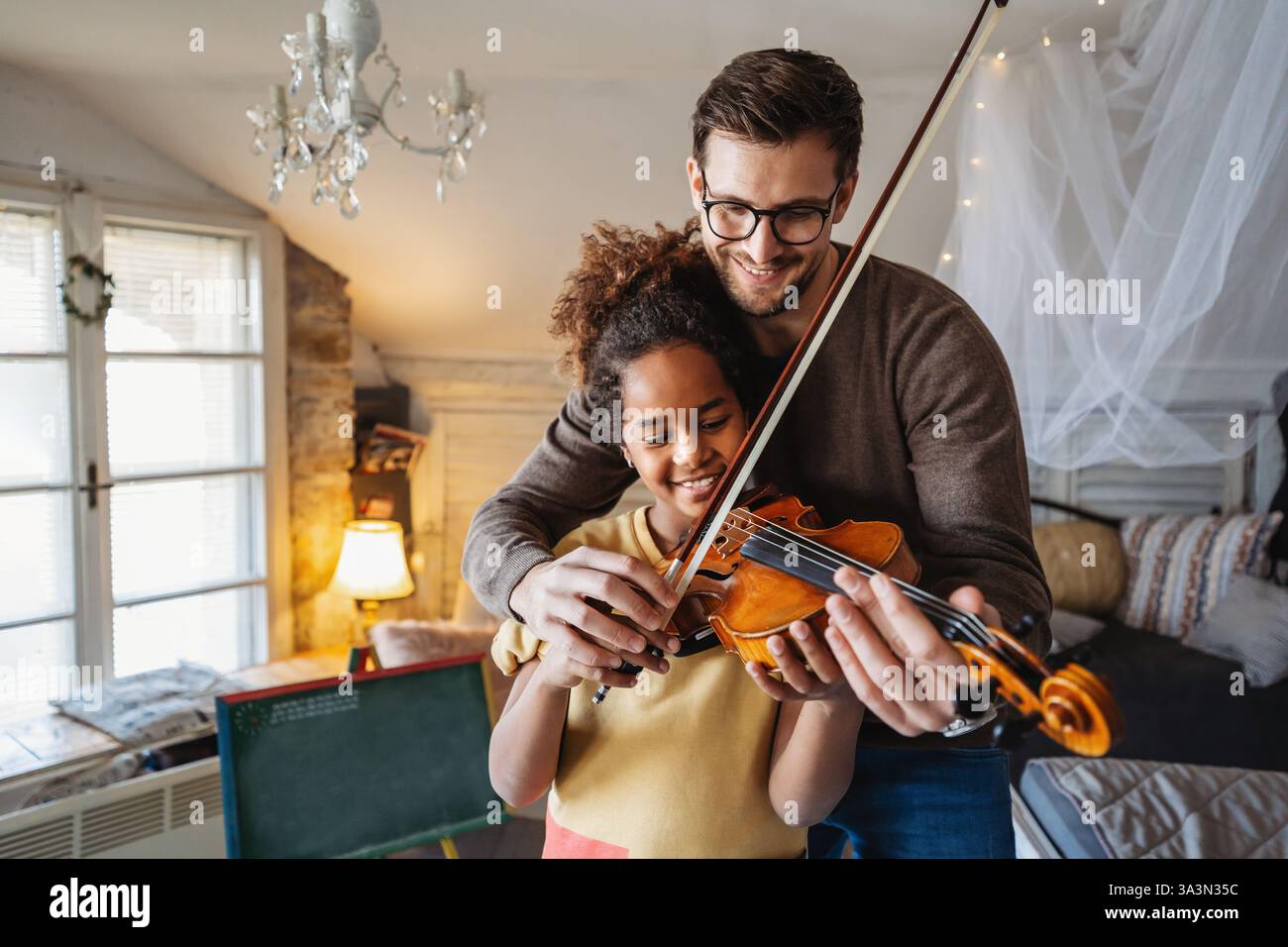 Private music man teacher giving violin lessons to African American ...