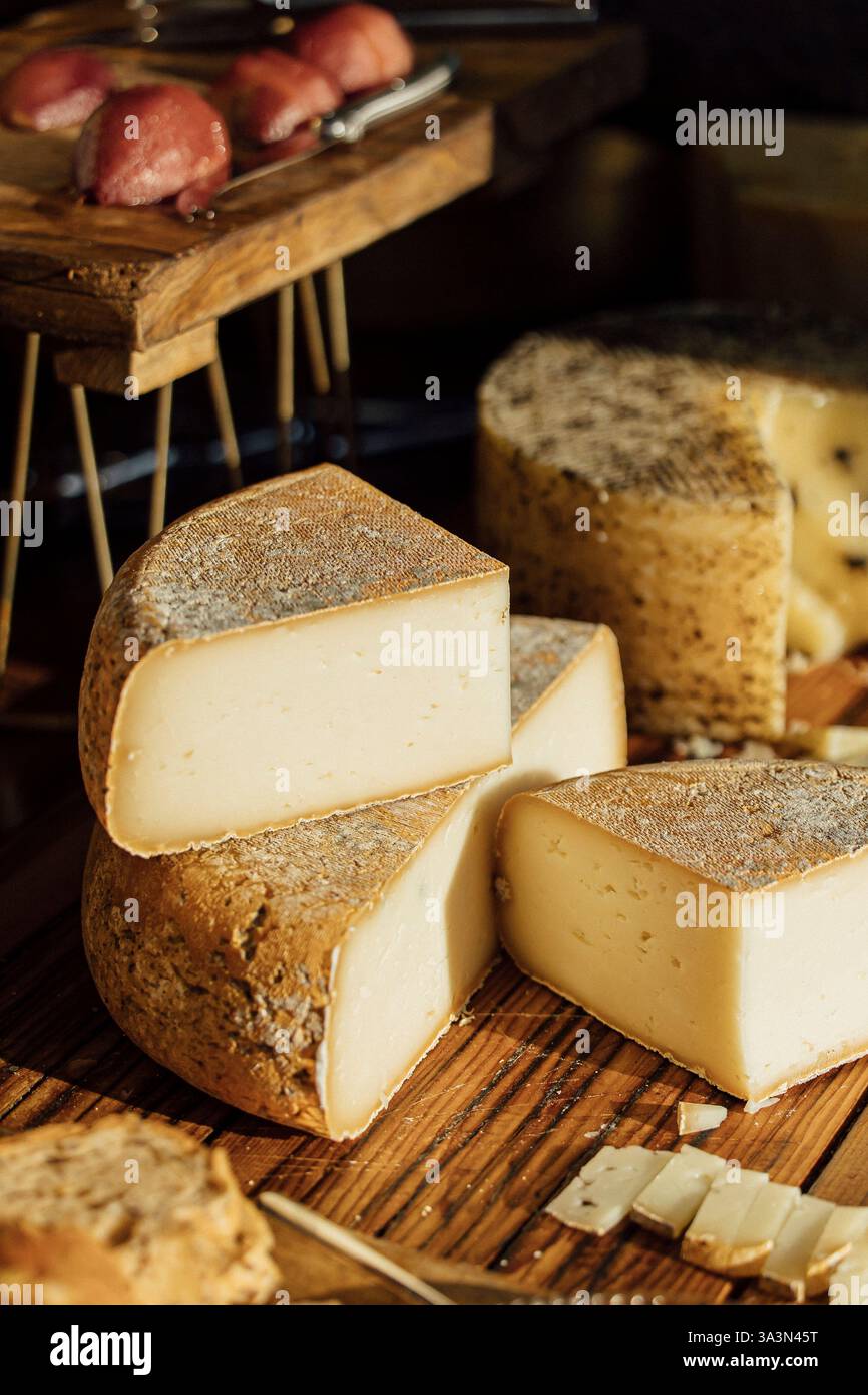 A beautifully arranged selection of artisanal cheeses displayed on a ...