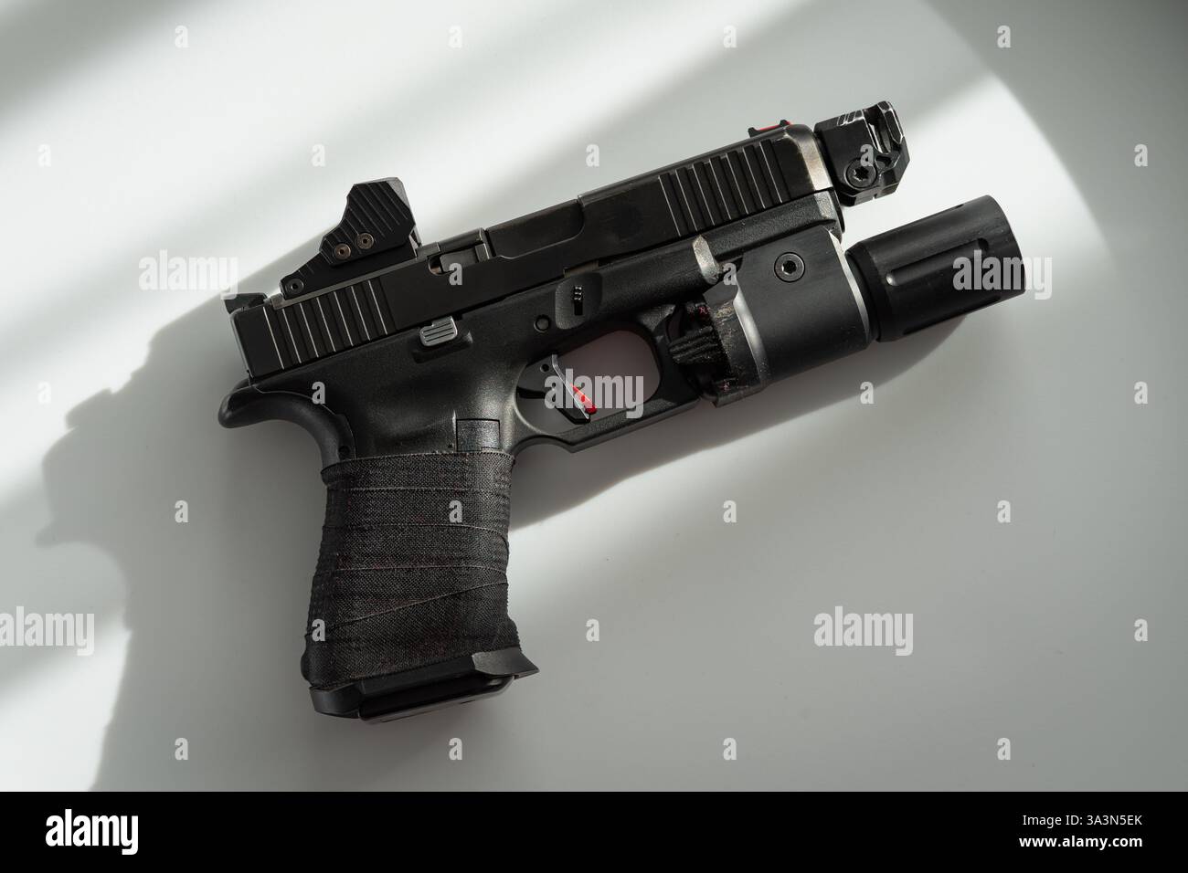 Civilian tactical weapon, pistol with flashlight and red dot sight on ...