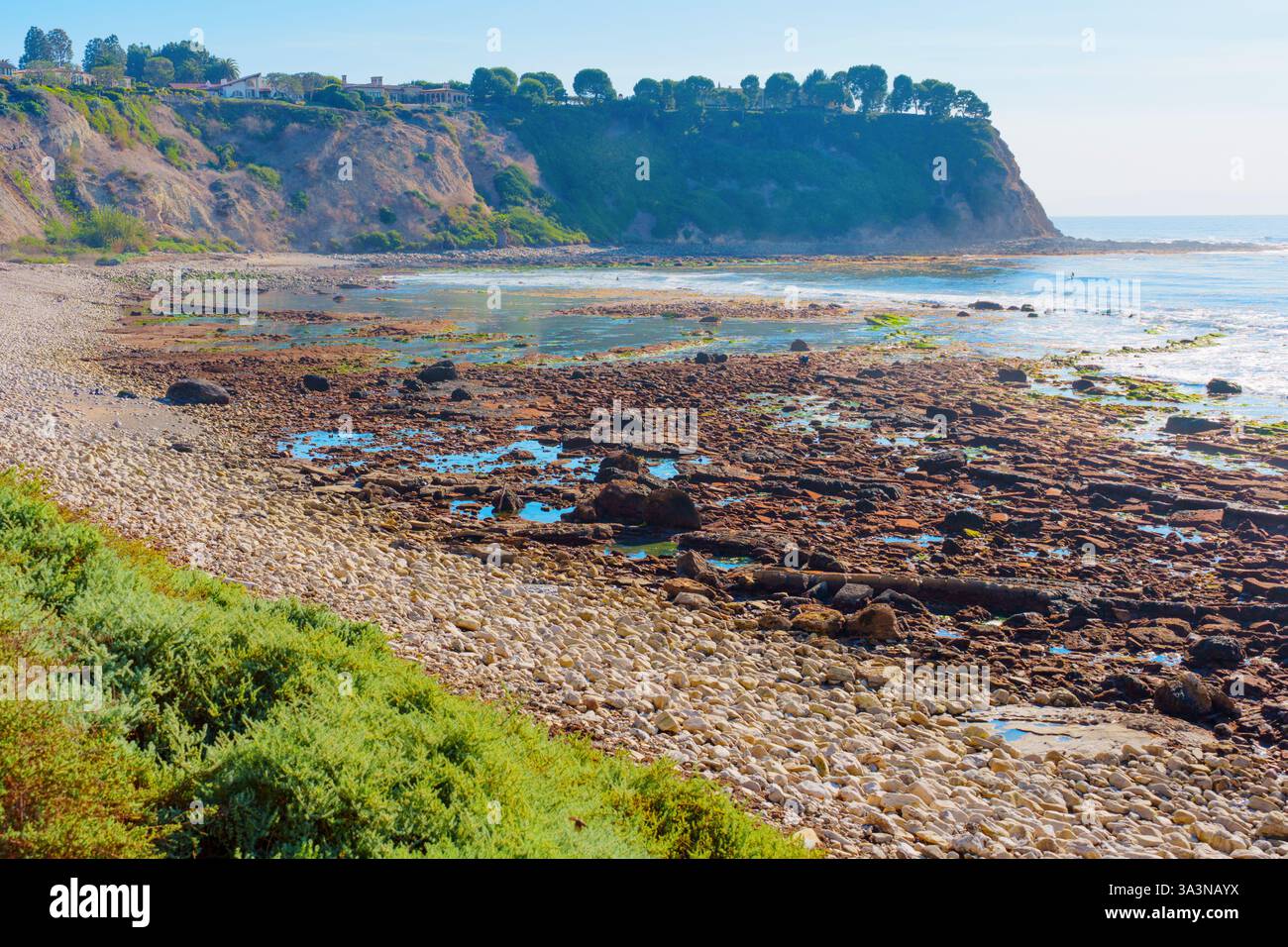 Wide-angle view showcases luxury real estate atop rugged cliffs in ...