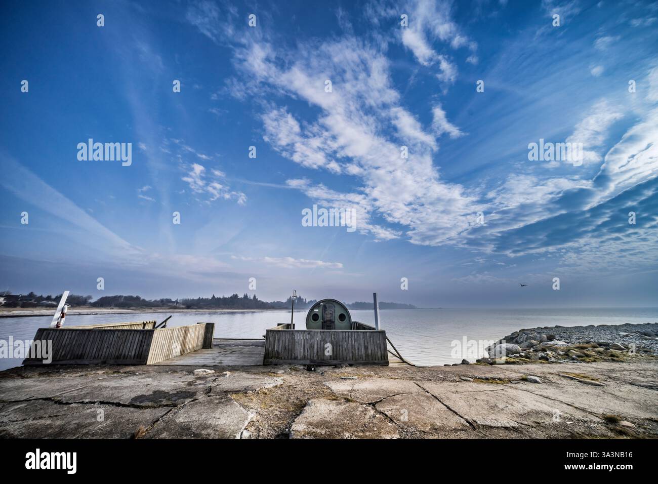 A peaceful seascape featuring stone barriers, colorful navigation buoys ...