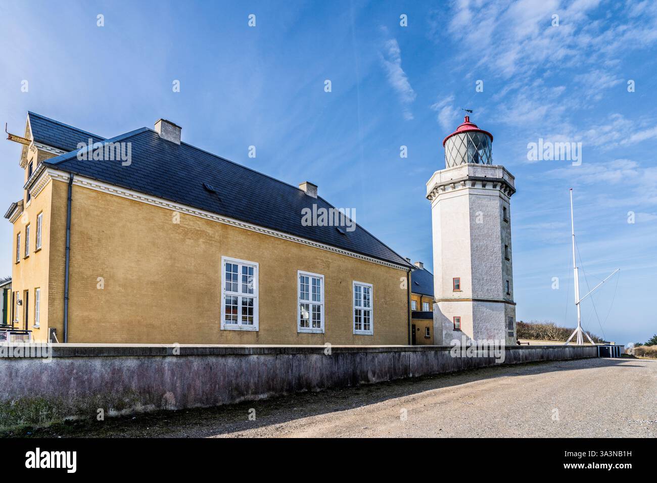 Beautiful historic lighthouse next to a charming structure under a ...