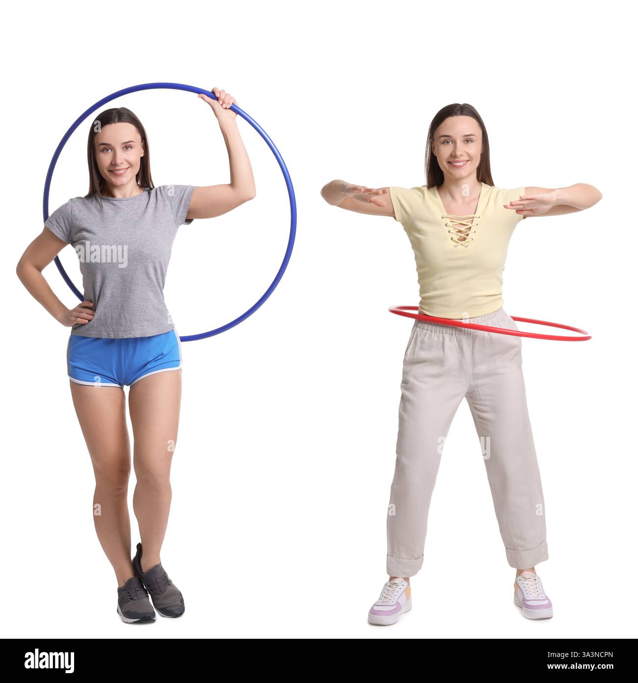 Beautiful young woman training with hula hoops on white background ...
