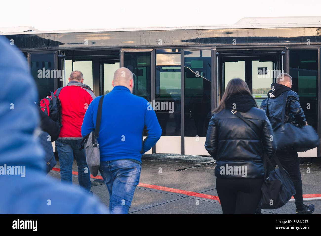 Passengers with Carry-On Luggage Walking to Airport Bus Stock Photo - Alamy