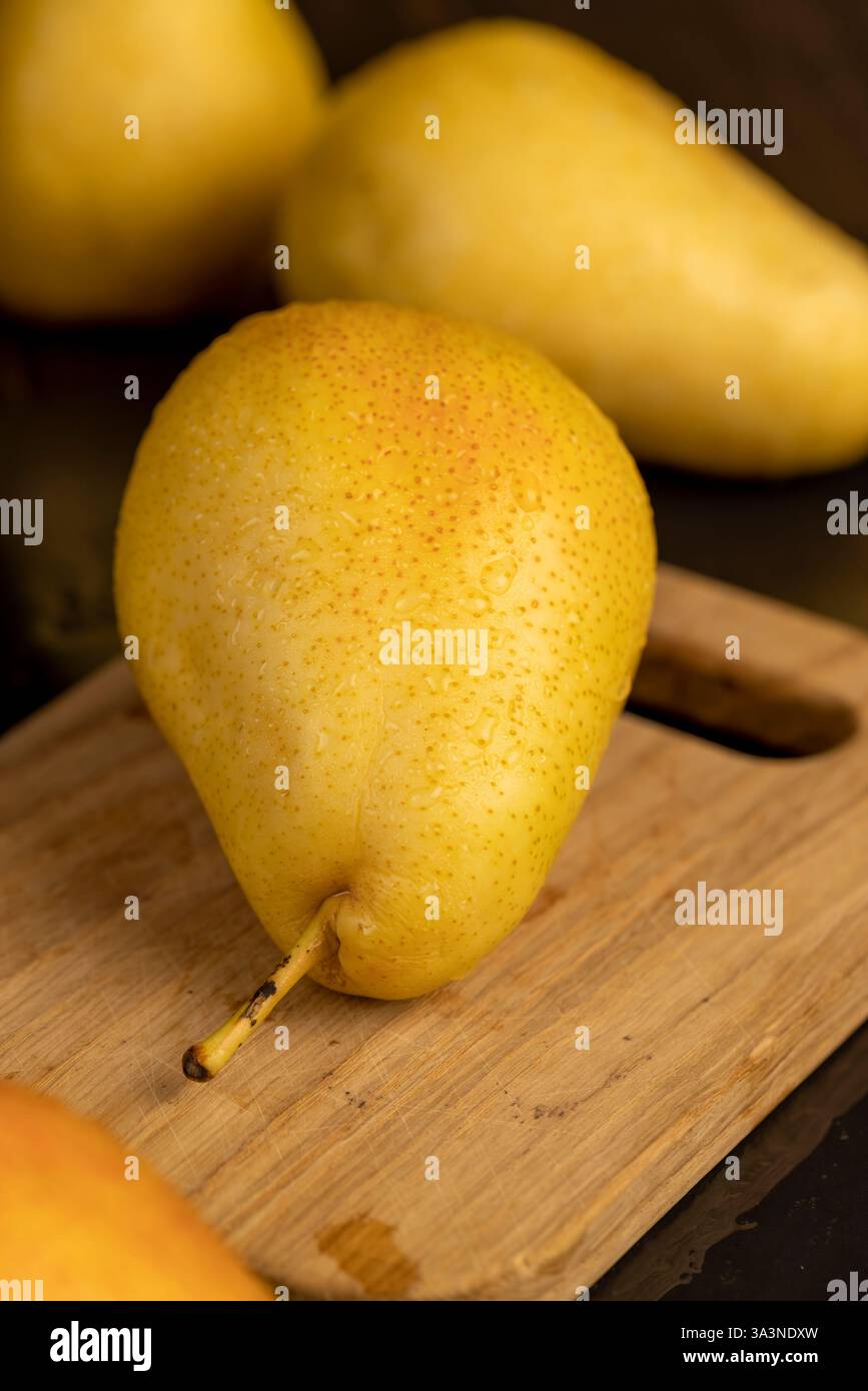 delicious yellow pears with red sides covered with drops of water ...