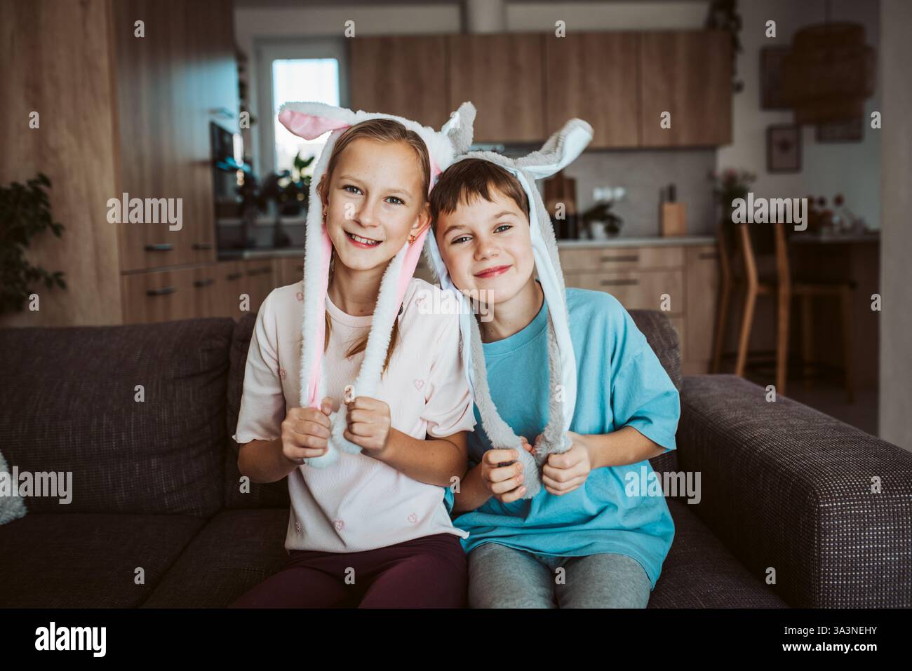 Brother and sister wearing bunny ears. Siblings celebrating Easter ...