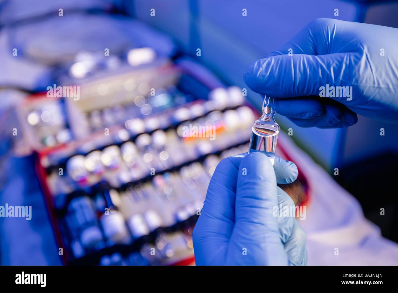 Close-up of paramedic hands holding ampoule with medication in ...
