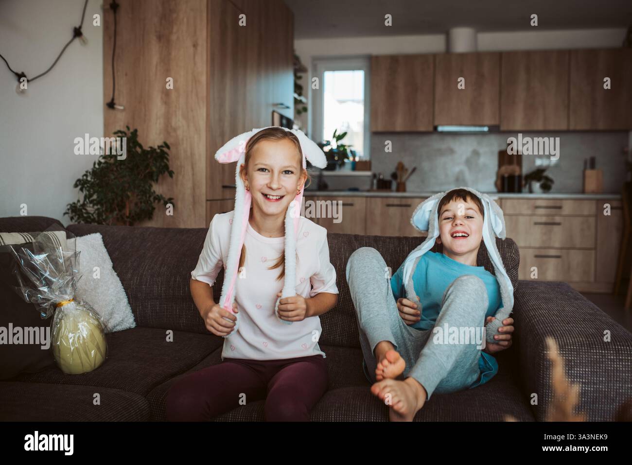 Brother and sister wearing bunny ears. Siblings celebrating Easter ...