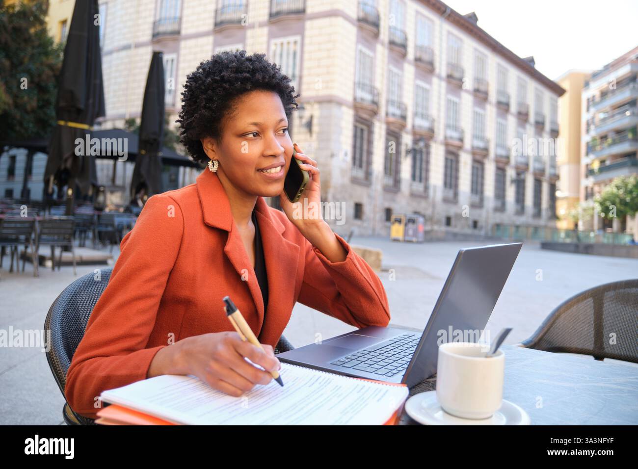 Professional woman working remotely while taking a phone call Stock ...