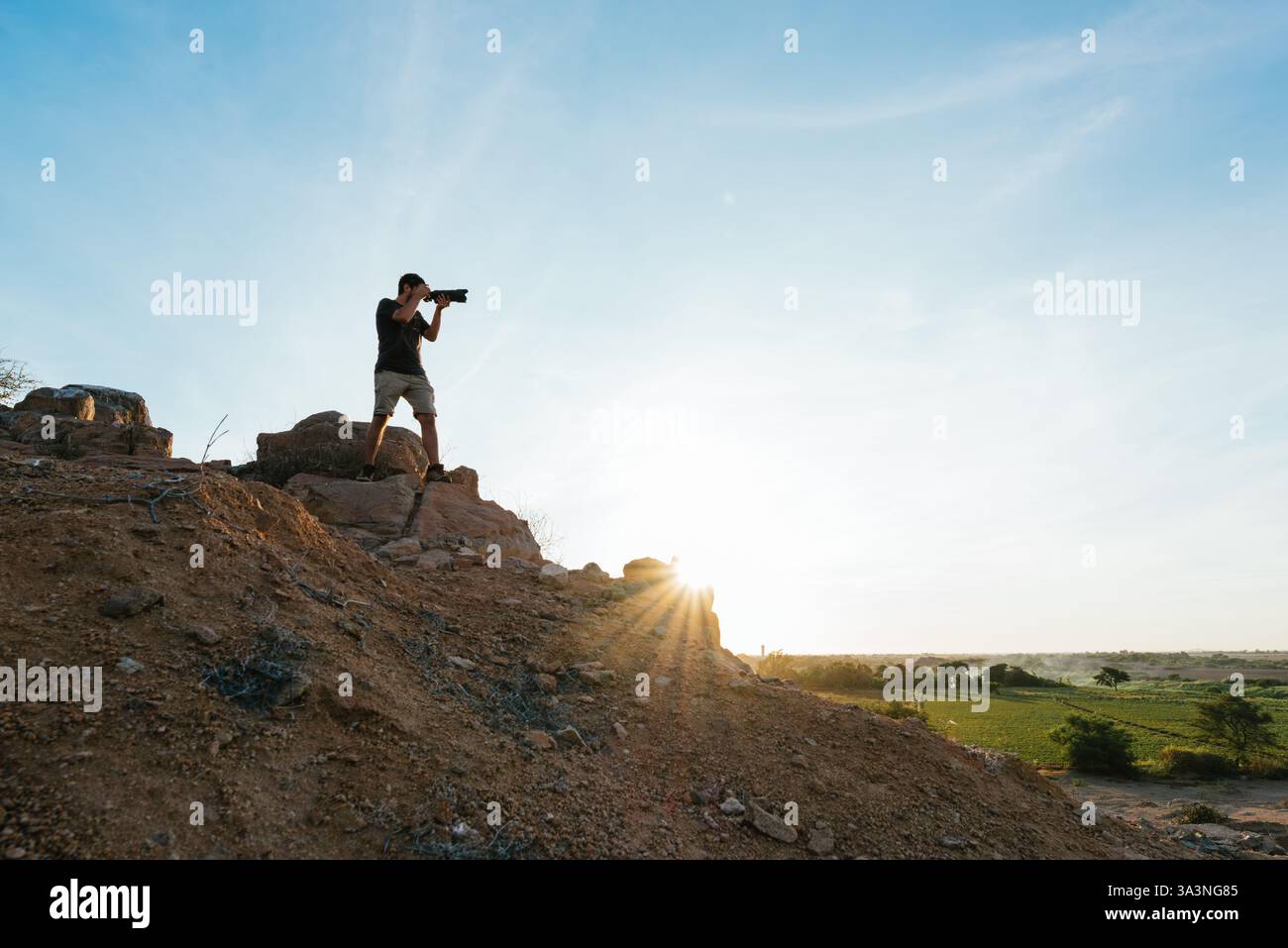 Side view of man photographer taking photos with telephoto lens Stock ...