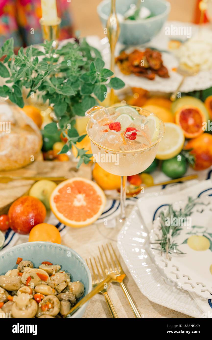 Citrus-themed table setting with cocktails and appetizers Stock Photo ...