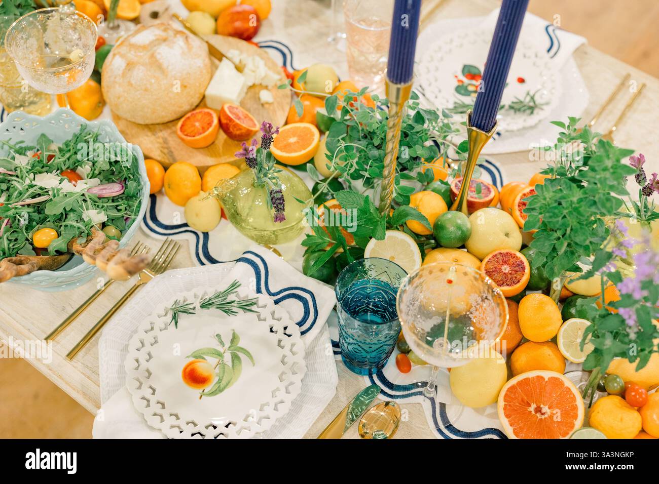 Citrus-themed table setting with vibrant fruit and greenery Stock Photo ...