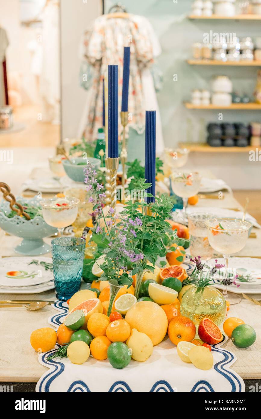Citrus-inspired tablescape with vibrant fruits and blue candles Stock ...