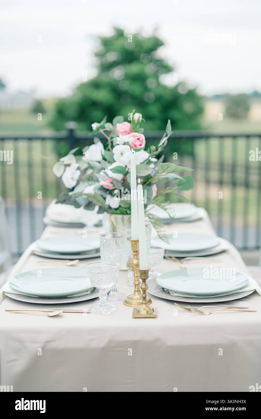 Outdoor reception tablescape with floral centerpiece and soft pastels ...