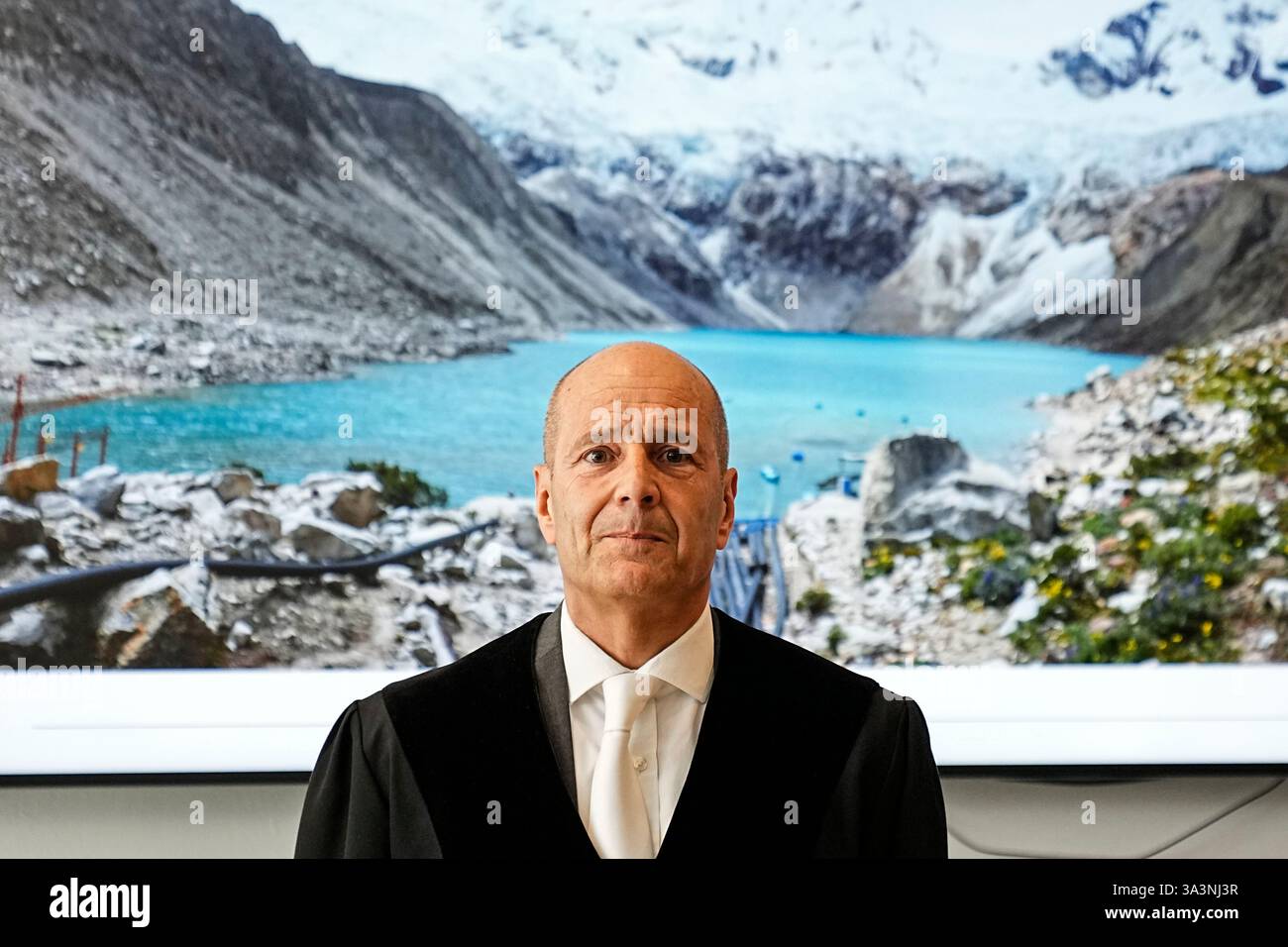Judge Rolf Meyer stands in front of a glacier picture in the courtroom ...
