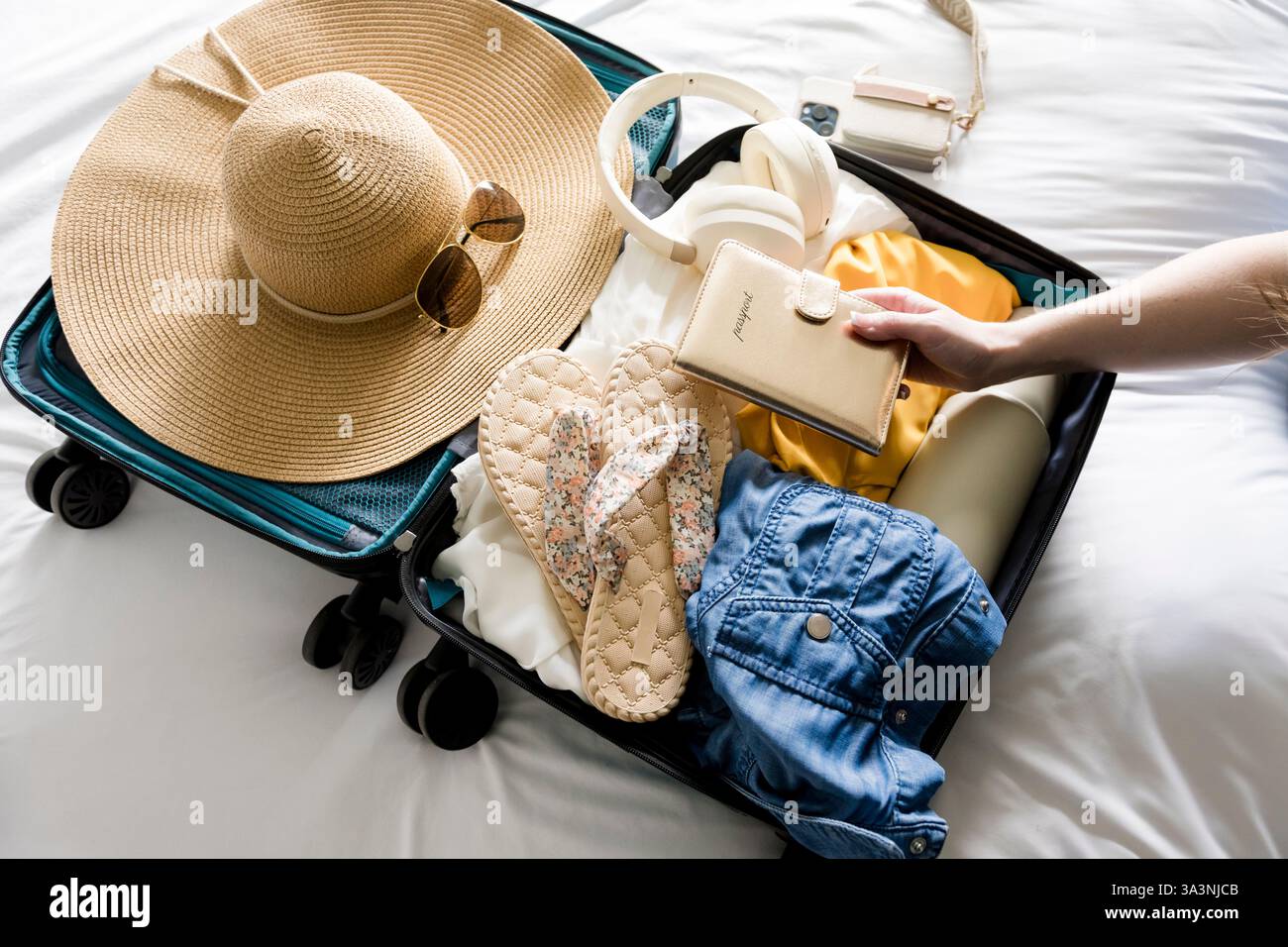Woman packing for summer vacation Stock Photo - Alamy