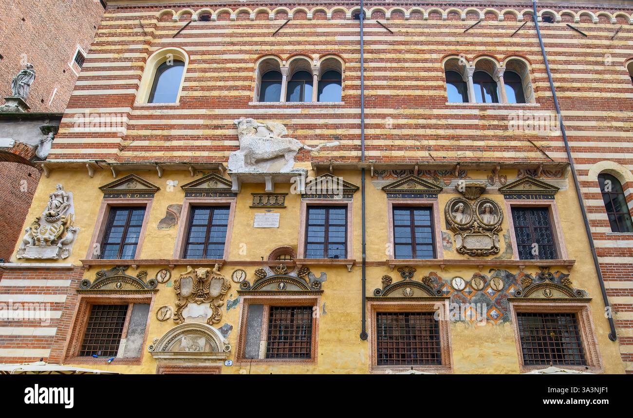 Verona, Italy. Traditional colorful building with balconies, shutter windows and multicolored ...