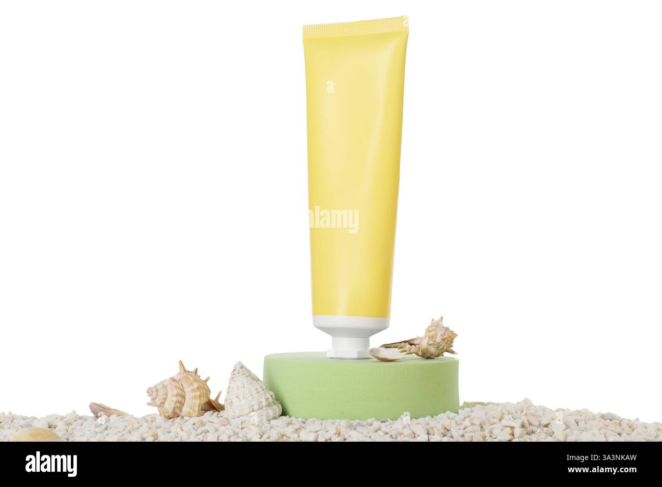 Tube of sun protection product and seashells on pebbles against white ...