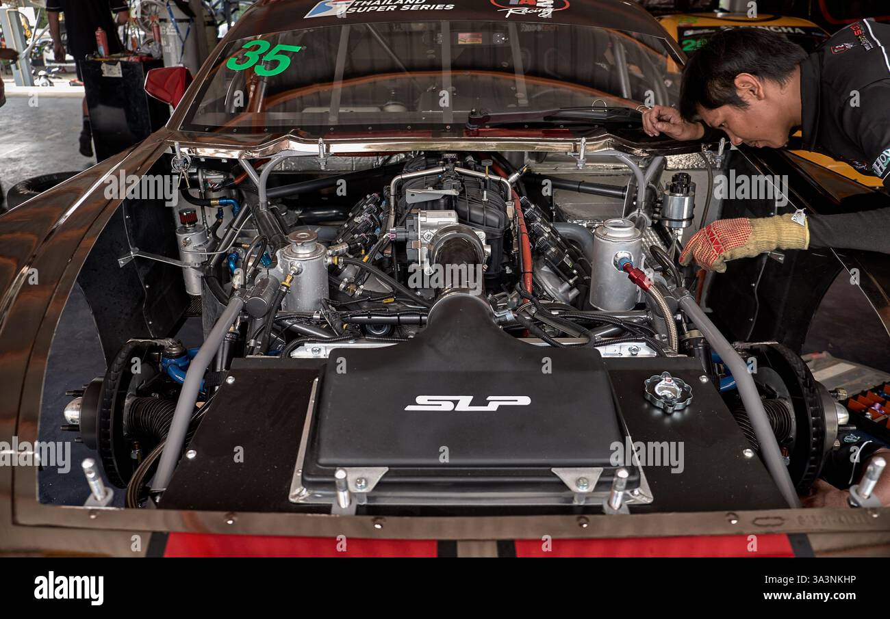 Motor mechanic working on the engine of a racing Ford Mustang car. Bira ...