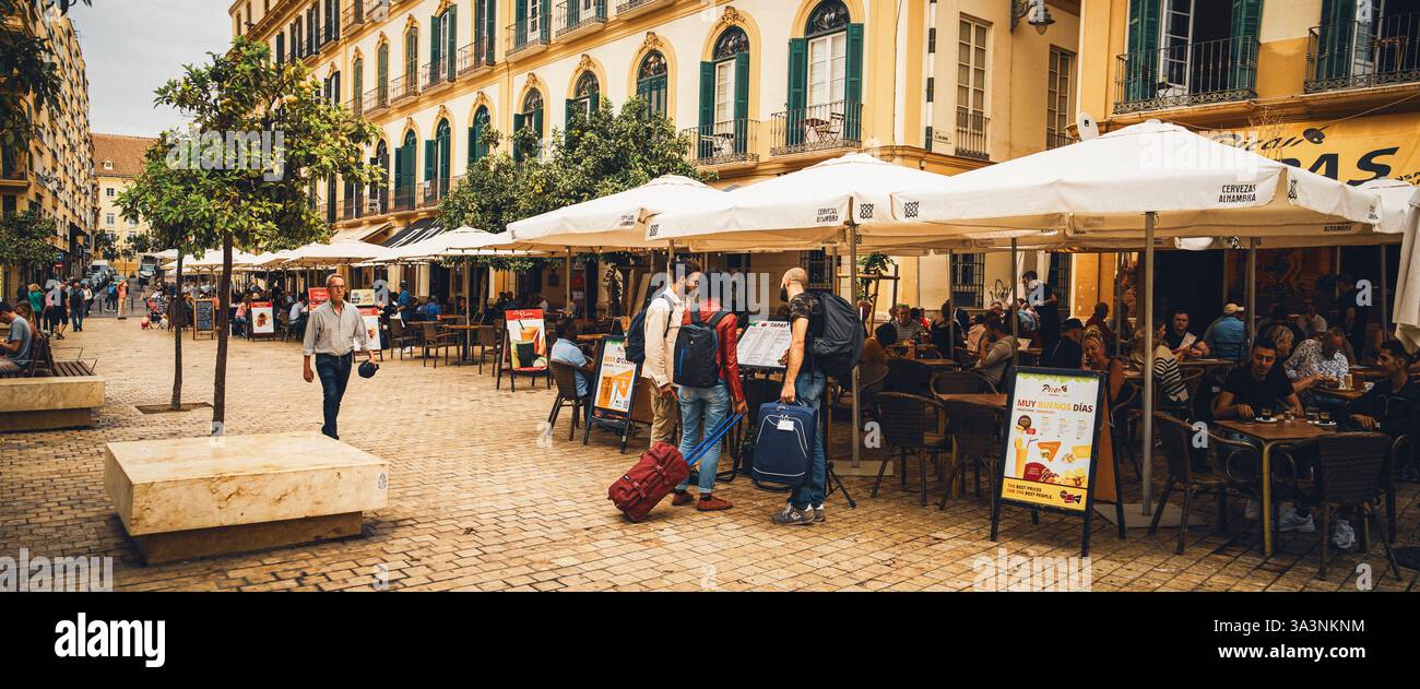 Malaga city tourist centre outdoor restaurant tables. Panoramic street ...