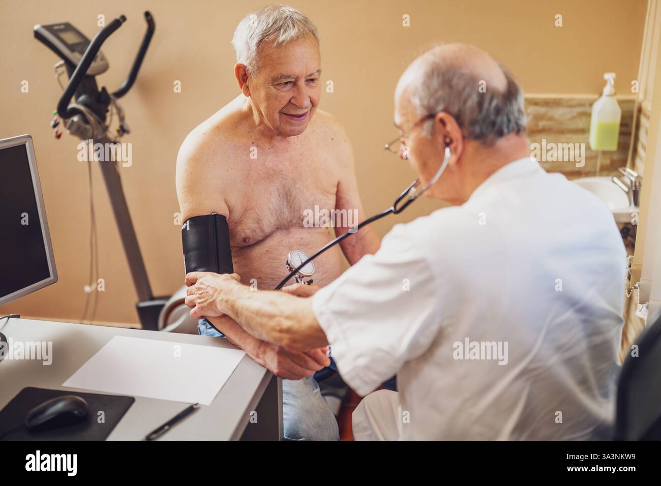 Patient is having exam at cardiologist. Doctor is measuring blood ...