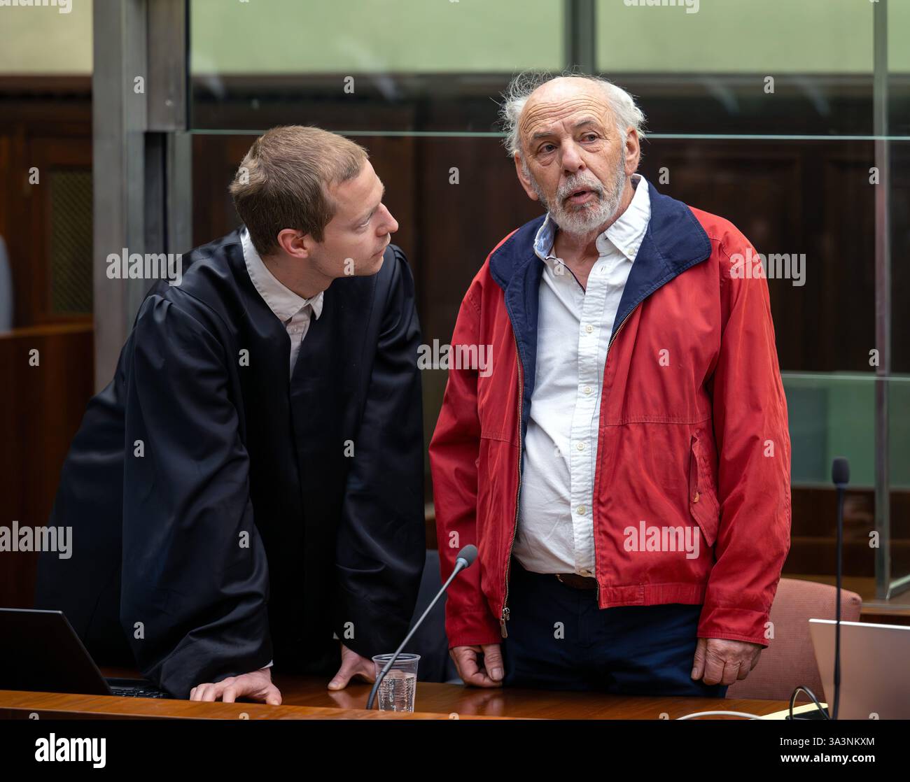 17 March 2025, Berlin: The accused Peter K. (r) talks to his defense ...