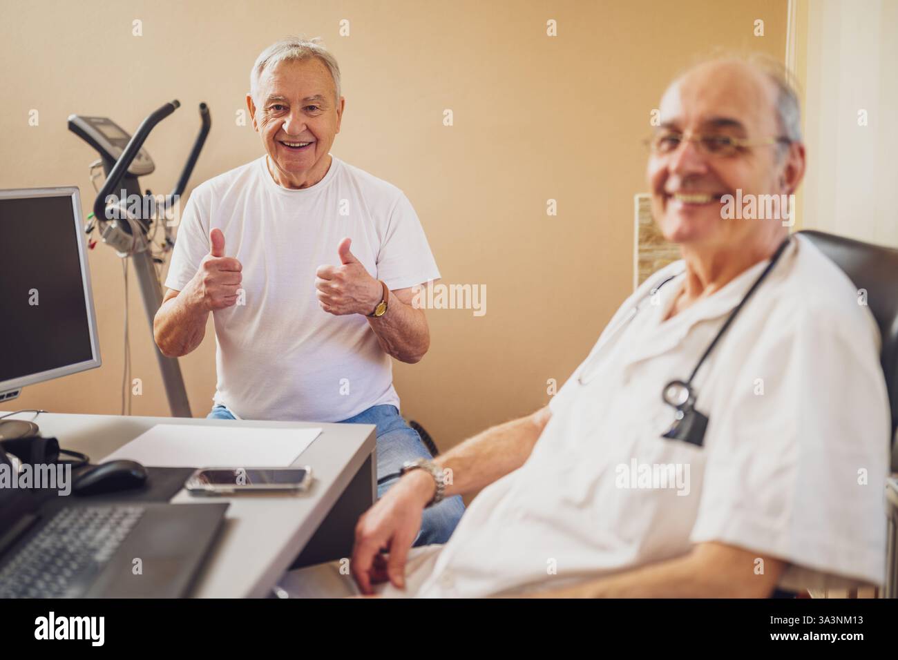 Happy patient having medical exam at cardiologist. Satisfied doctor and ...