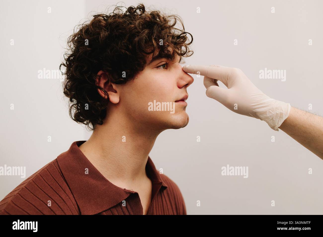 ENT doctor touching nose of patient before rhinoplasty or septoplasty ...