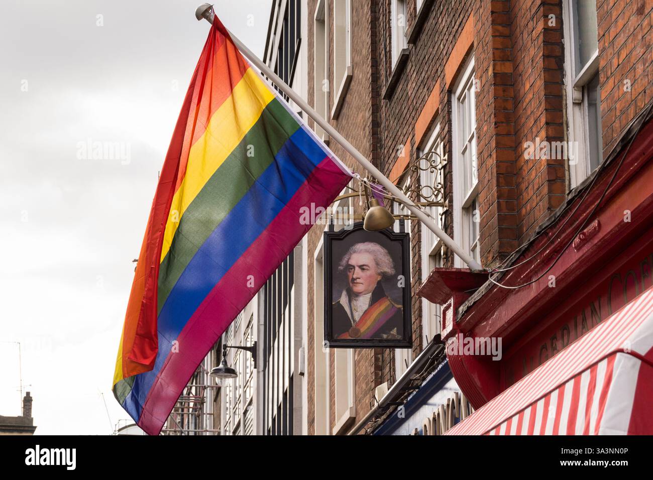 Pub sign and the Gay Pride Rainbow flag outside the world famous ...