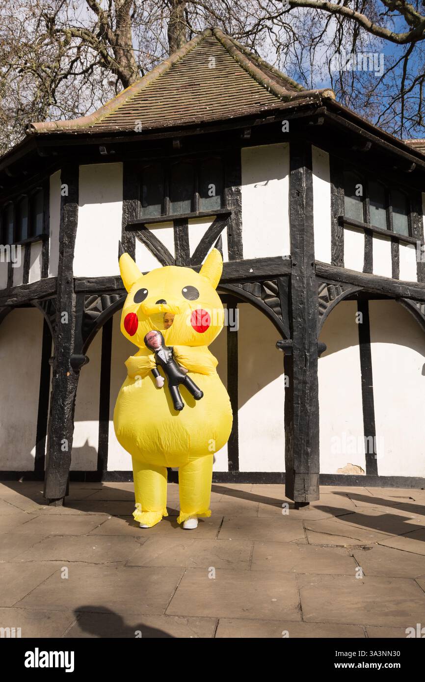 Tourists and a Pokémon Pikachu character in Soho Square in front of the ...
