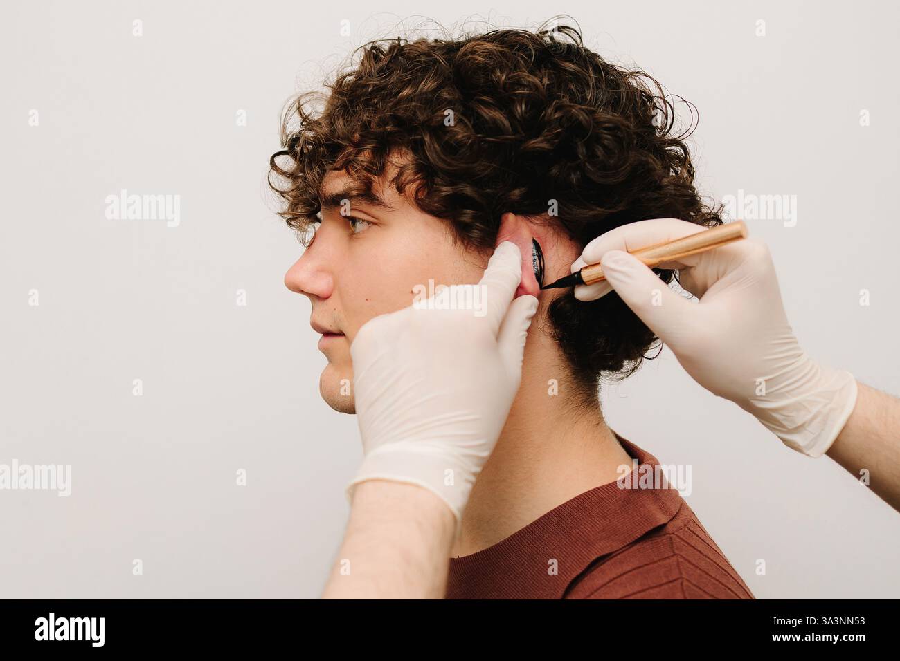 Applying markup on ear hi-res stock photography and images - Alamy