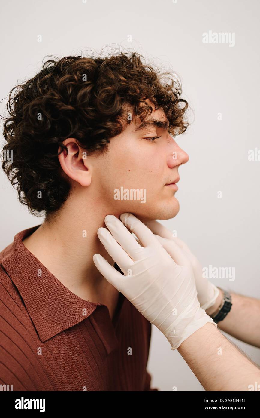 ENT doctor palpates the neck to determine inflammation of the lymph ...