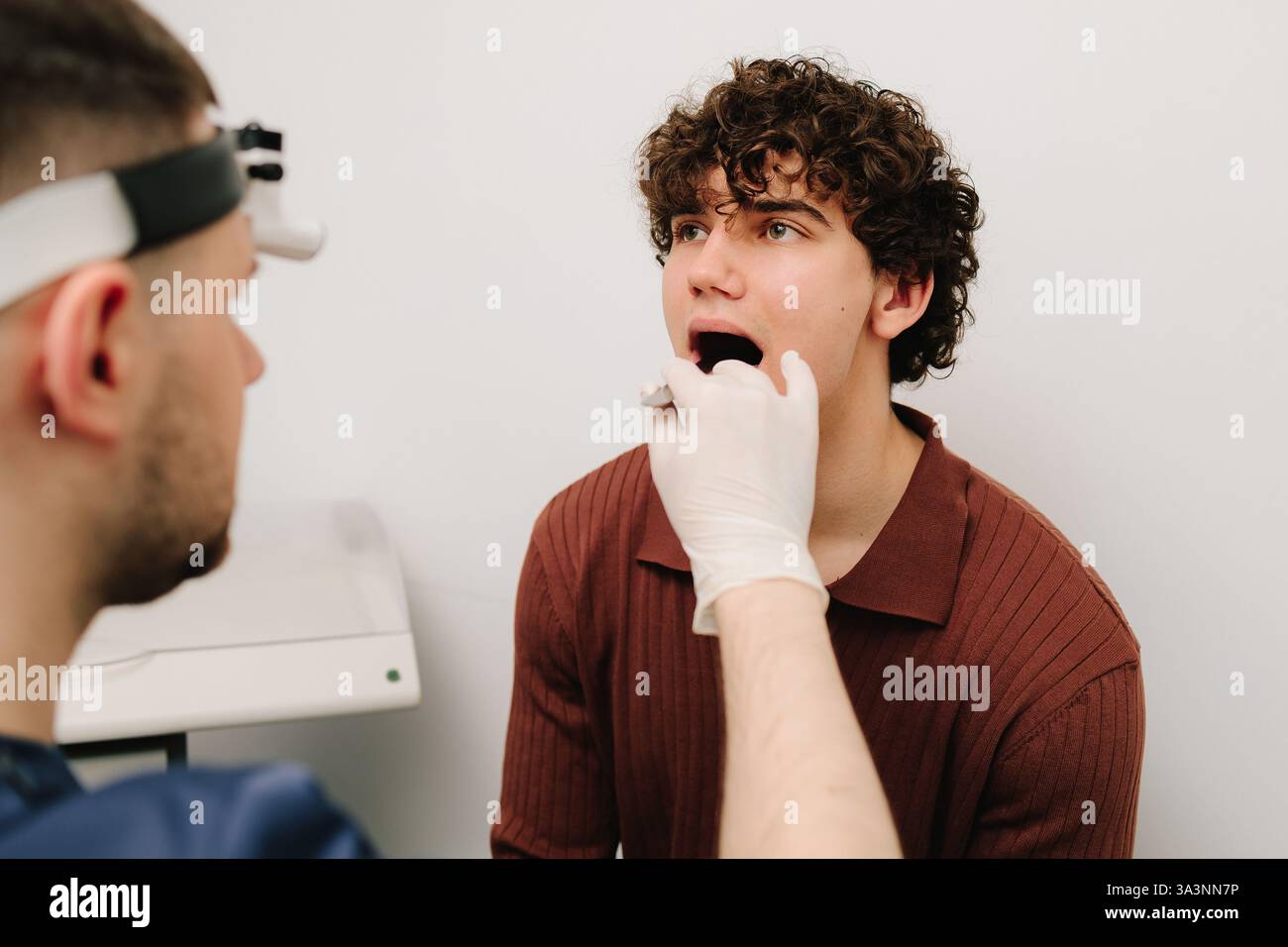 ENT examination of the throat with an inspection spatula. ENT doctor ...