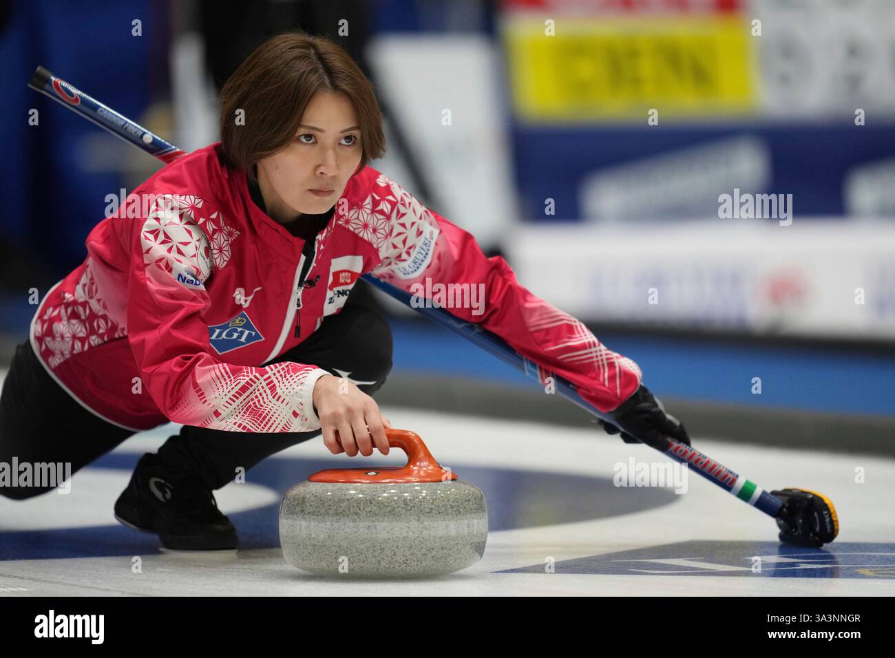 Japan's skip Sayaka Yoshimura, releases the stone during the match against Switzerland at the ...