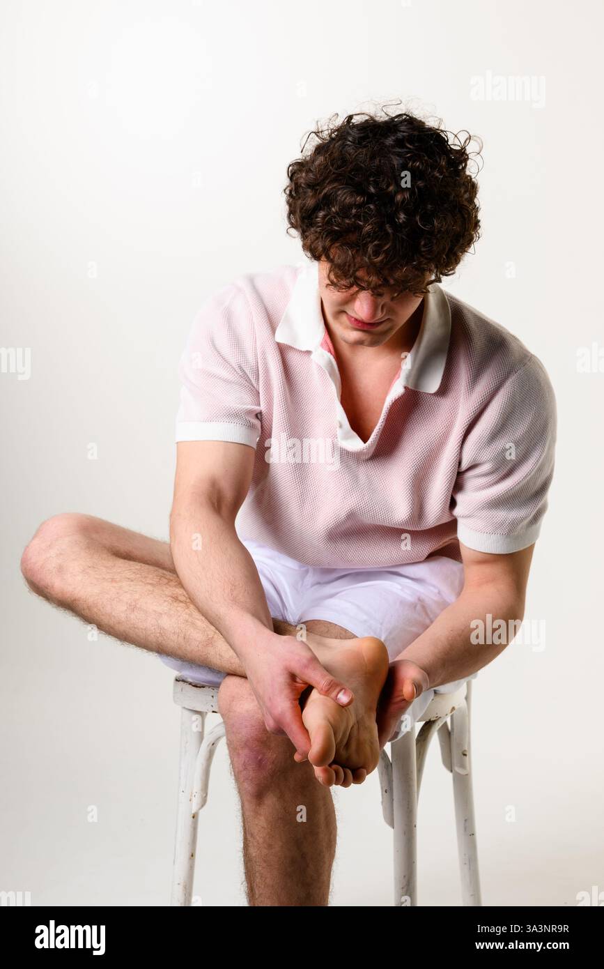 Plantar warts. Young man is getting small growth on the side of his ...
