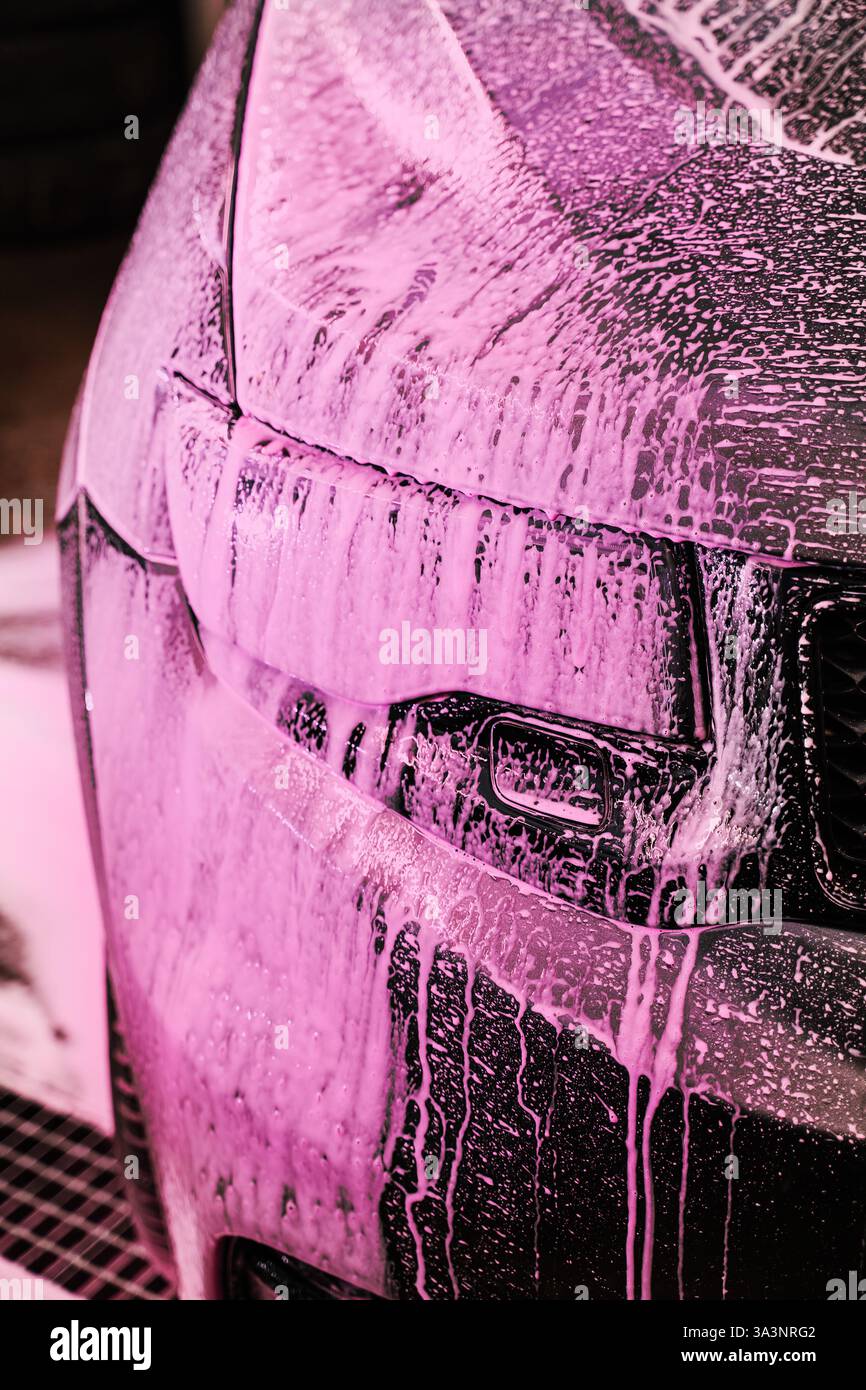 Pink foam on the car. The process of cleaning car with pink foam ...