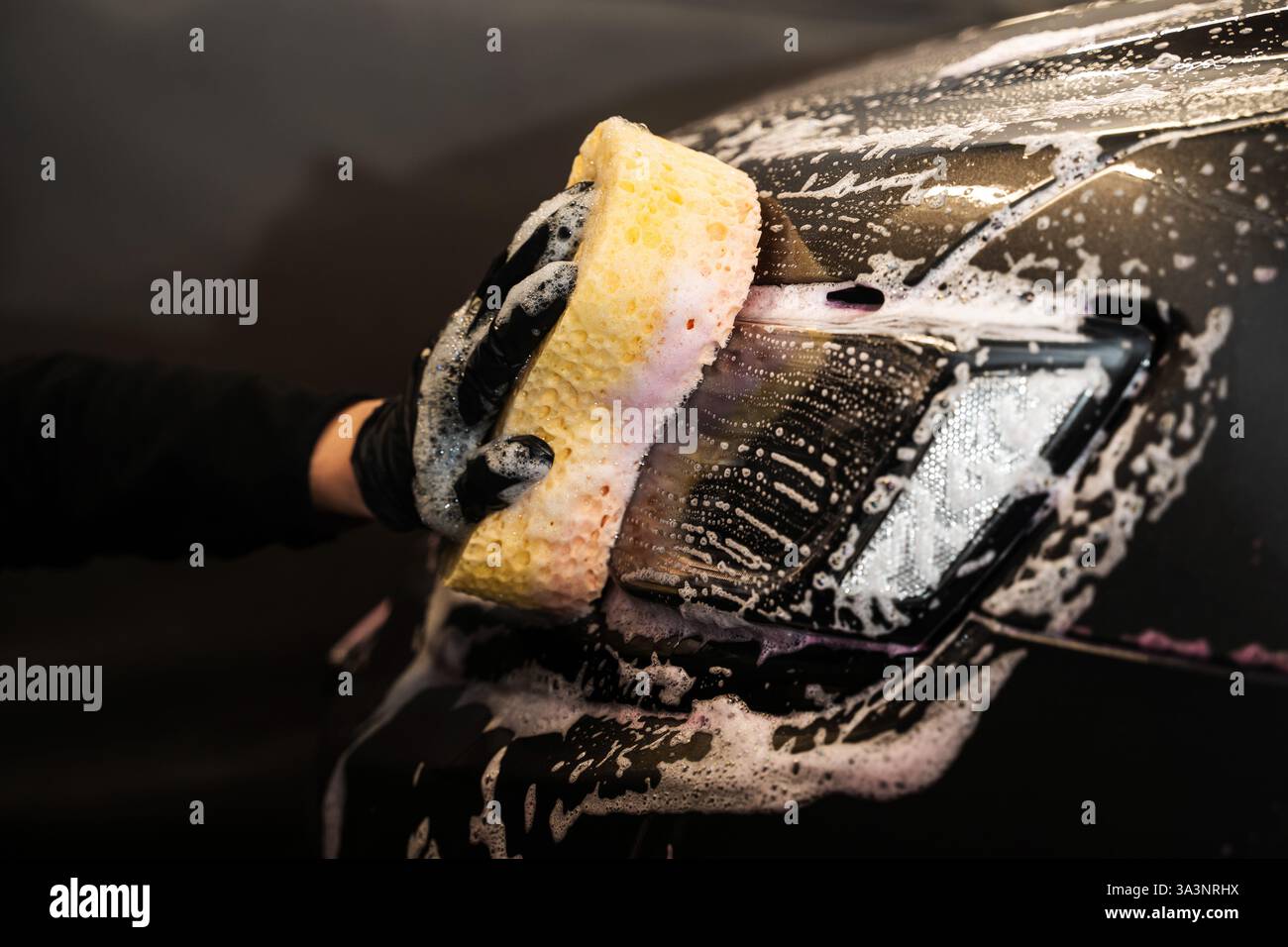 A manual vehicle washing on a self service car wash. The process of ...