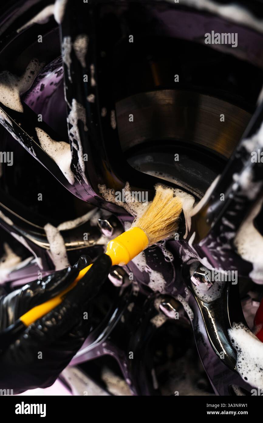 Vehicle detailing service at the car wash. The process of rims cleaning ...