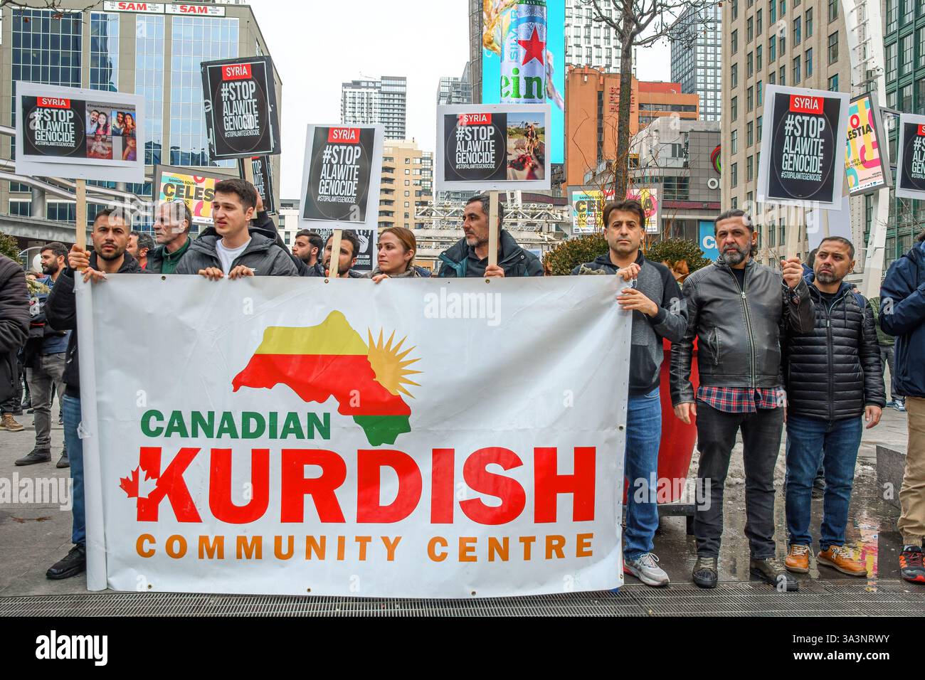 People holding a sign of the Canadian Kurdish Communty Centre in a ...