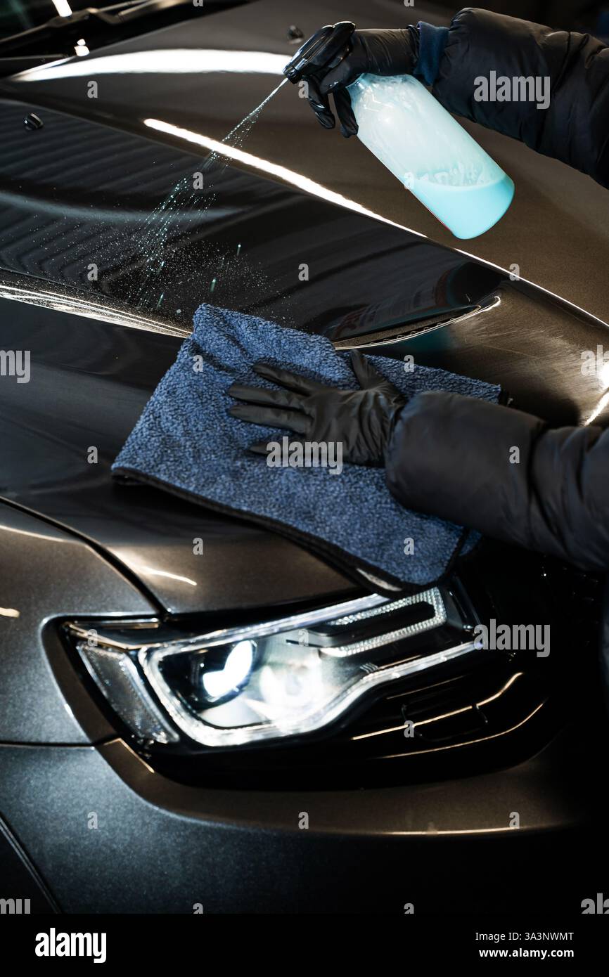 Process of car detailing at car service. Applying spray of quick ...