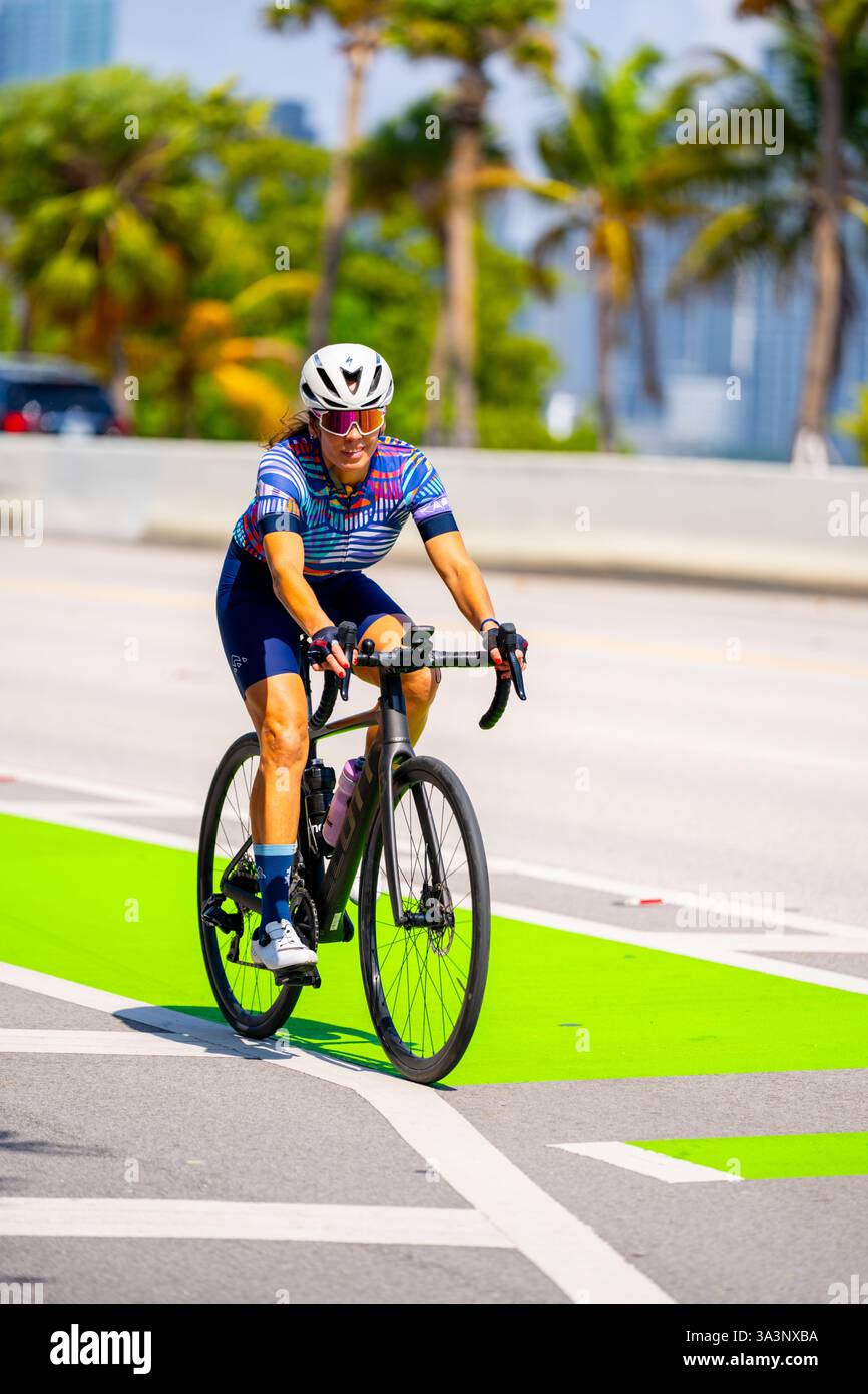 Woman rides a race bike in Miami Key Biscayne Florida Stock Photo - Alamy