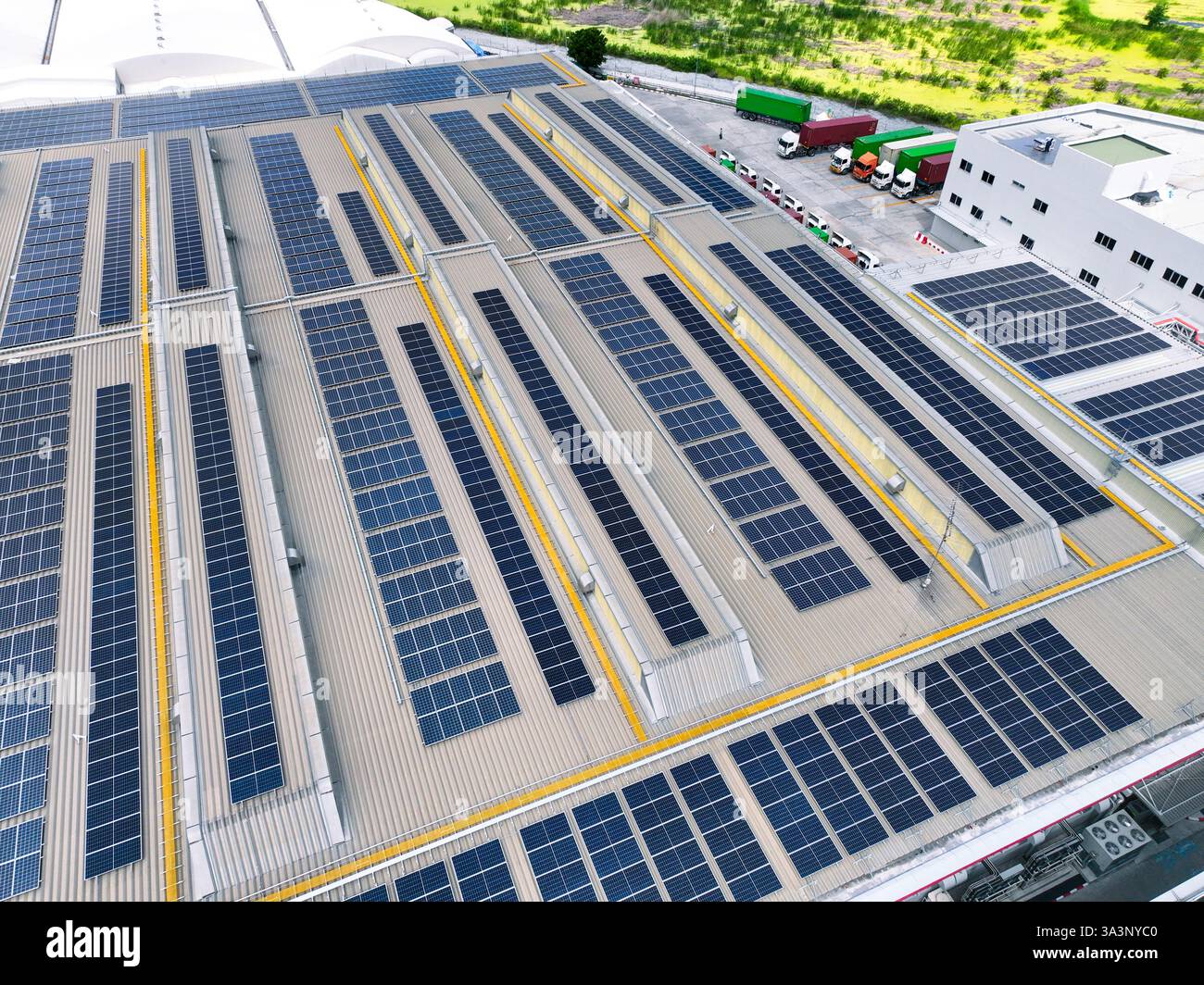 Solar-powered warehouse facility with freight trucks at loading docks ...