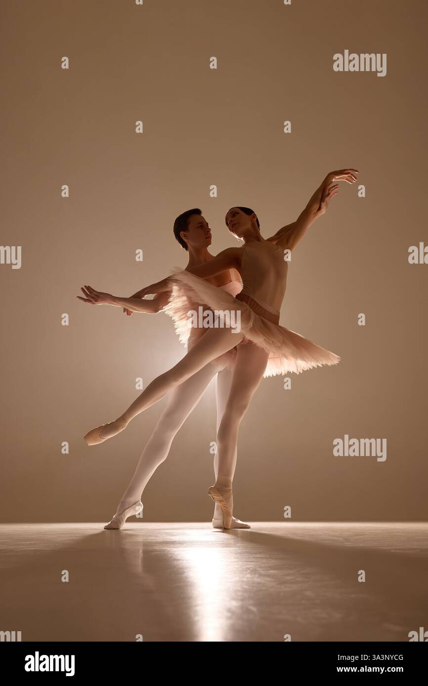 Dancers create sweeping lines in perfect synchrony, warm stage light outlining expressive ...