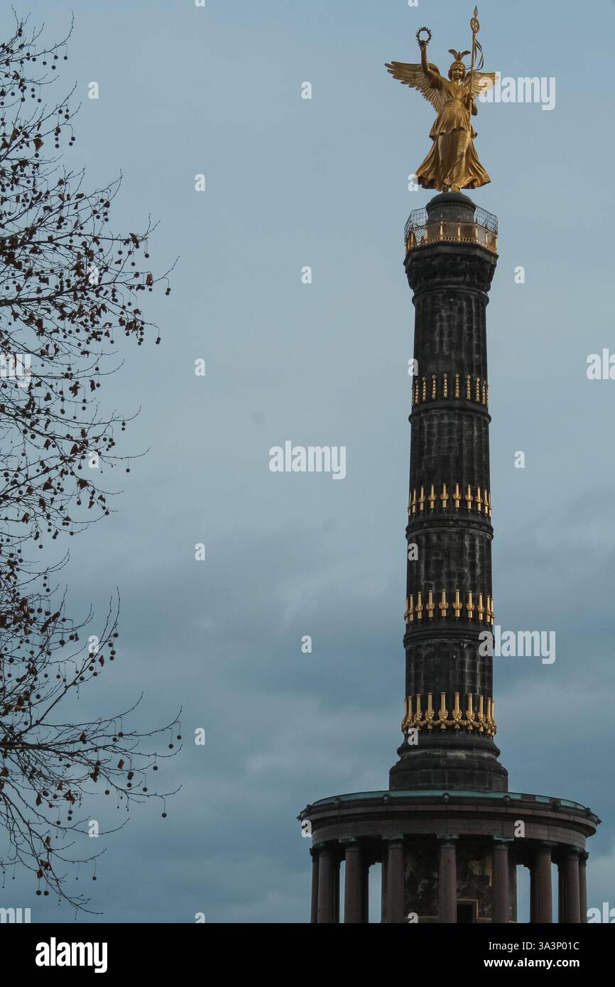 A stunning golden angel is perched on top of a tall column in Berlin ...