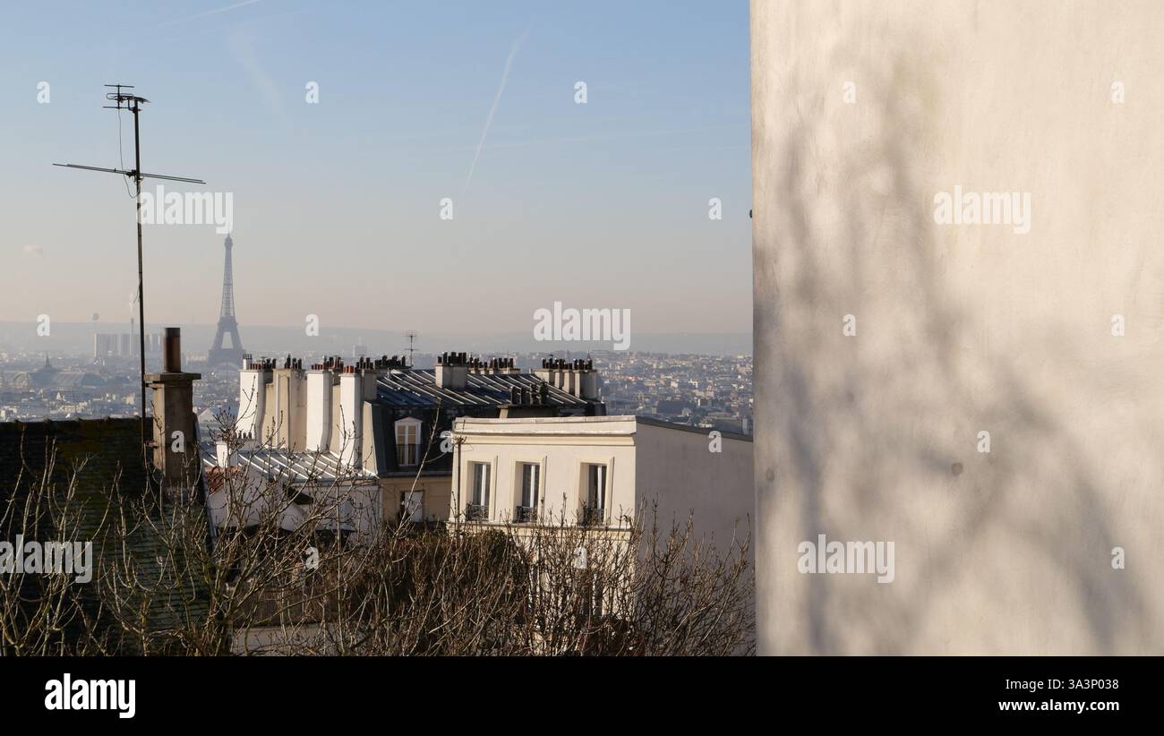 A rooftop in Paris showcases the Eiffel Tower in the distance against a ...