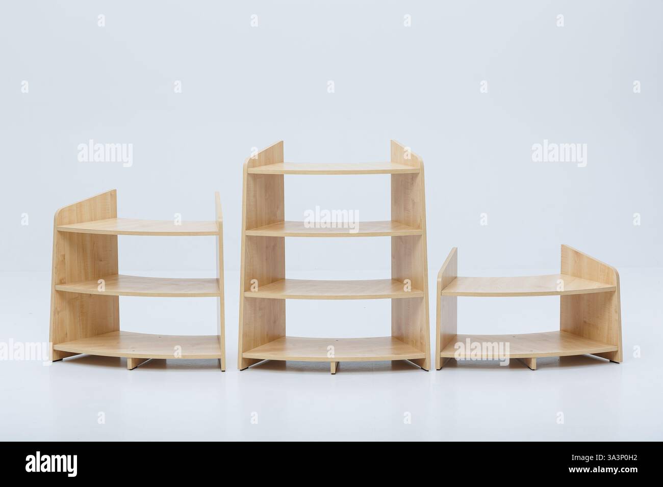 Three beautifully crafted wooden shelves are neatly lined up in a row ...